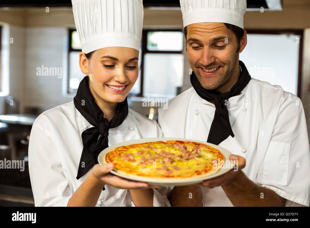 Chef man holding two pizza hi-res stock photography and images - Alamy