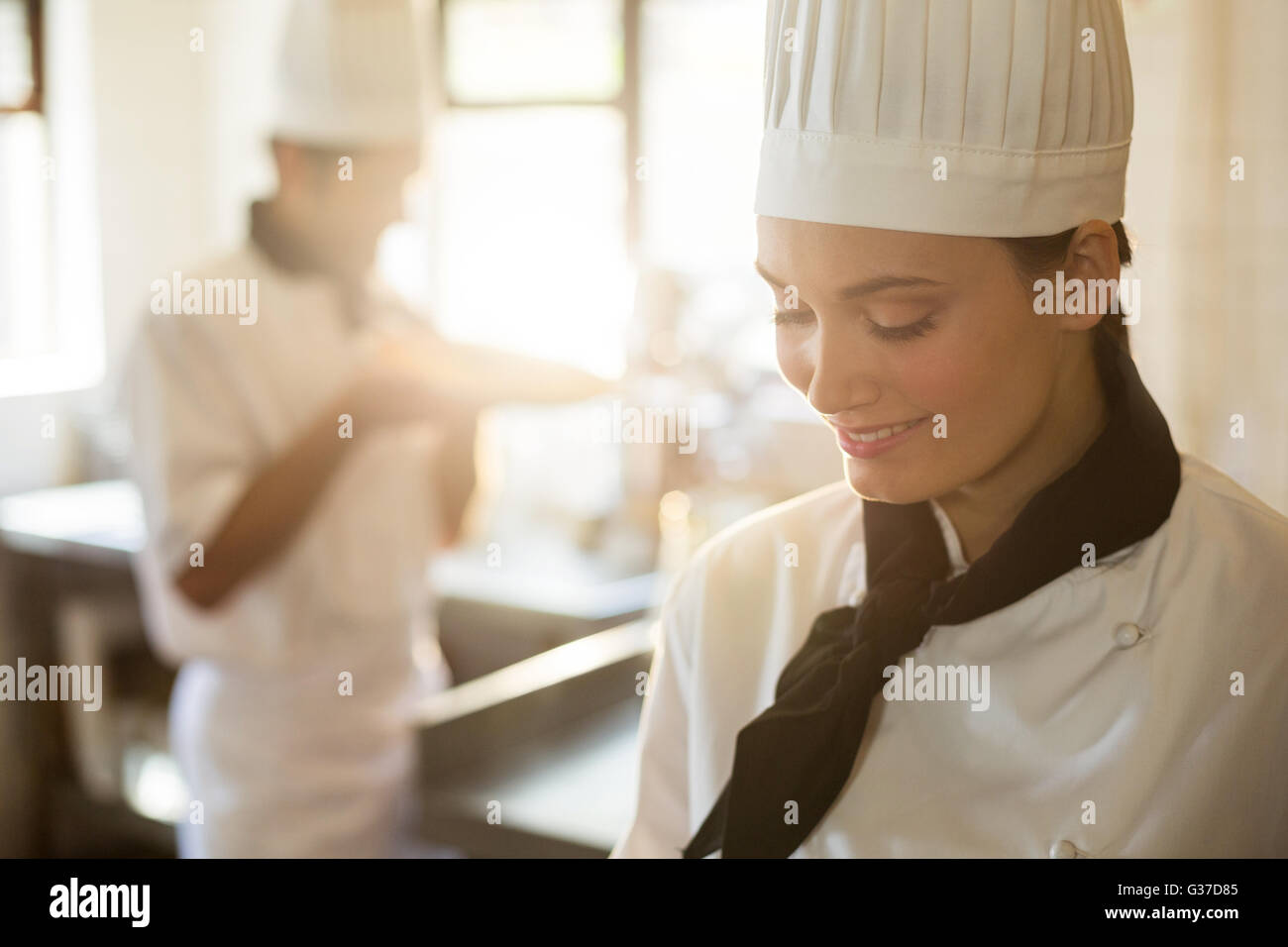 Happy head chef cooking at stove Stock Photo - Alamy