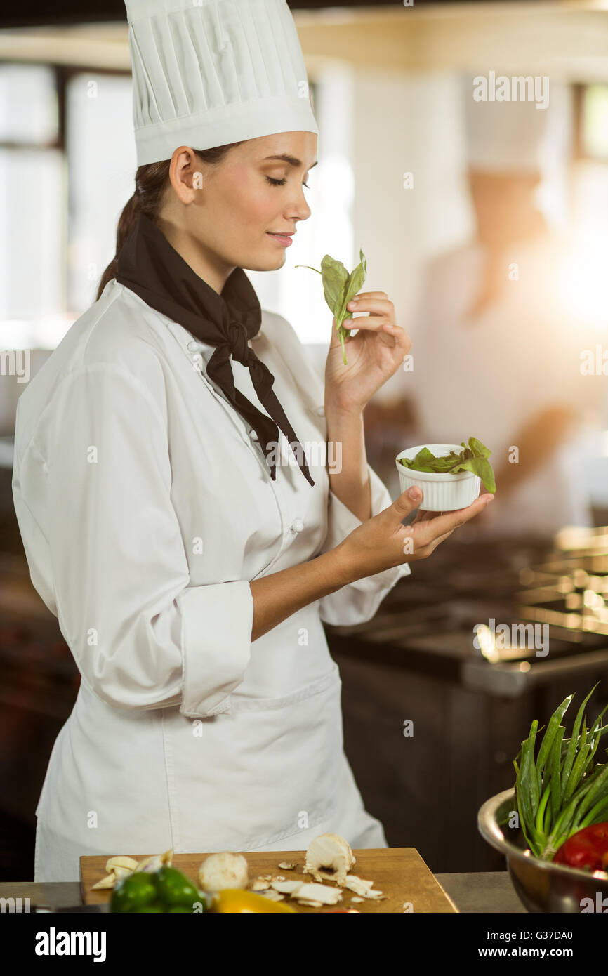 Young female chef smelling herb Stock Photo - Alamy