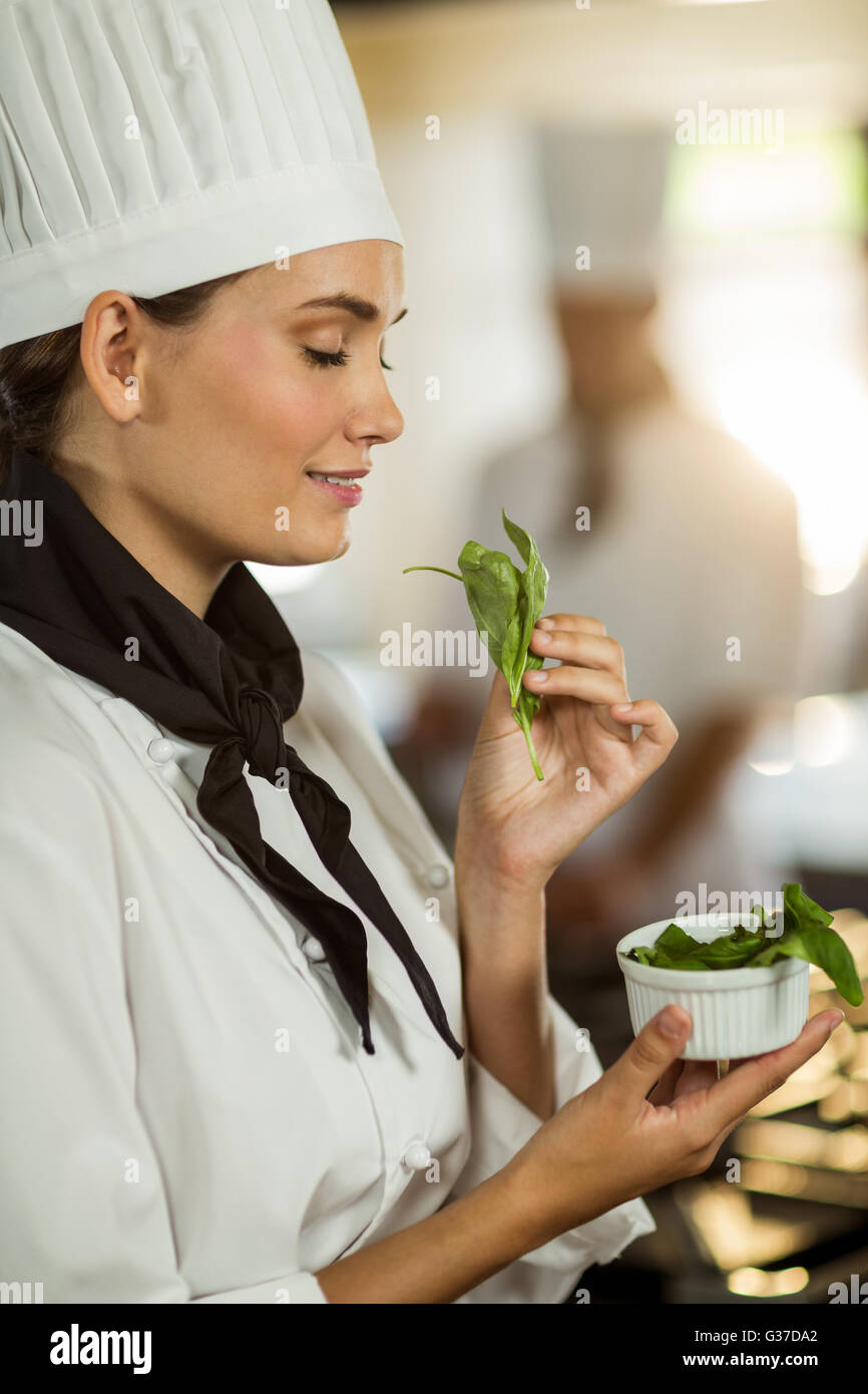 Young female chef smelling herb Stock Photo - Alamy