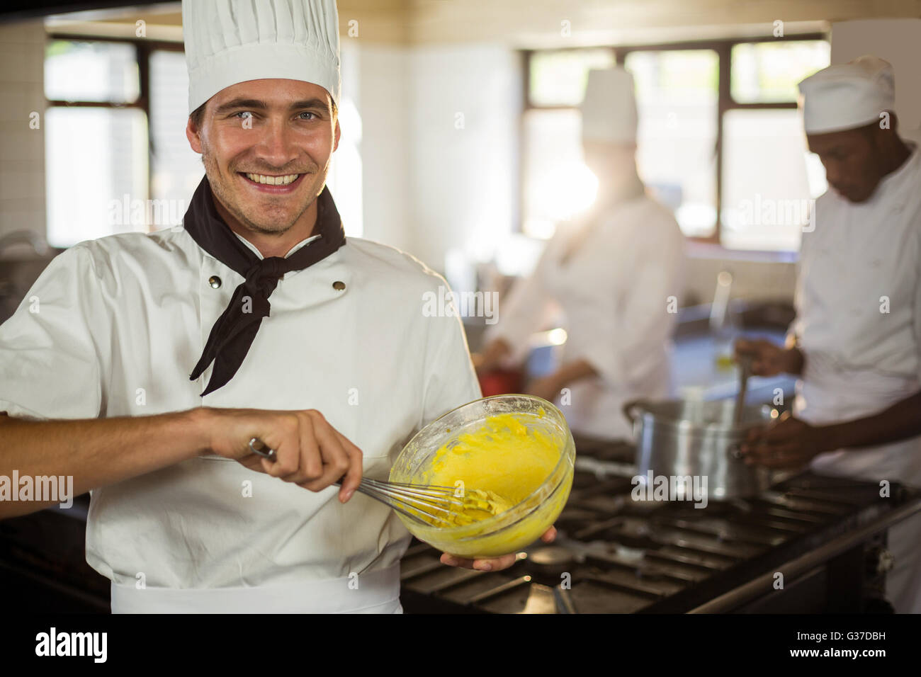 Portrait of smiling chef mixing dough Stock Photo - Alamy