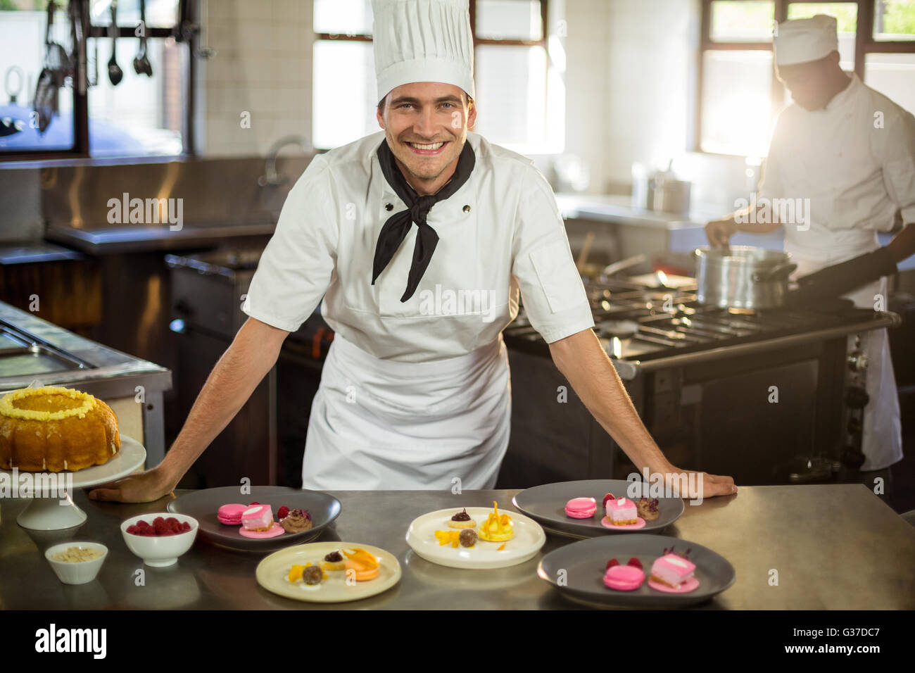 Portrait of smiling chef presenting dessert plates Stock Photo - Alamy