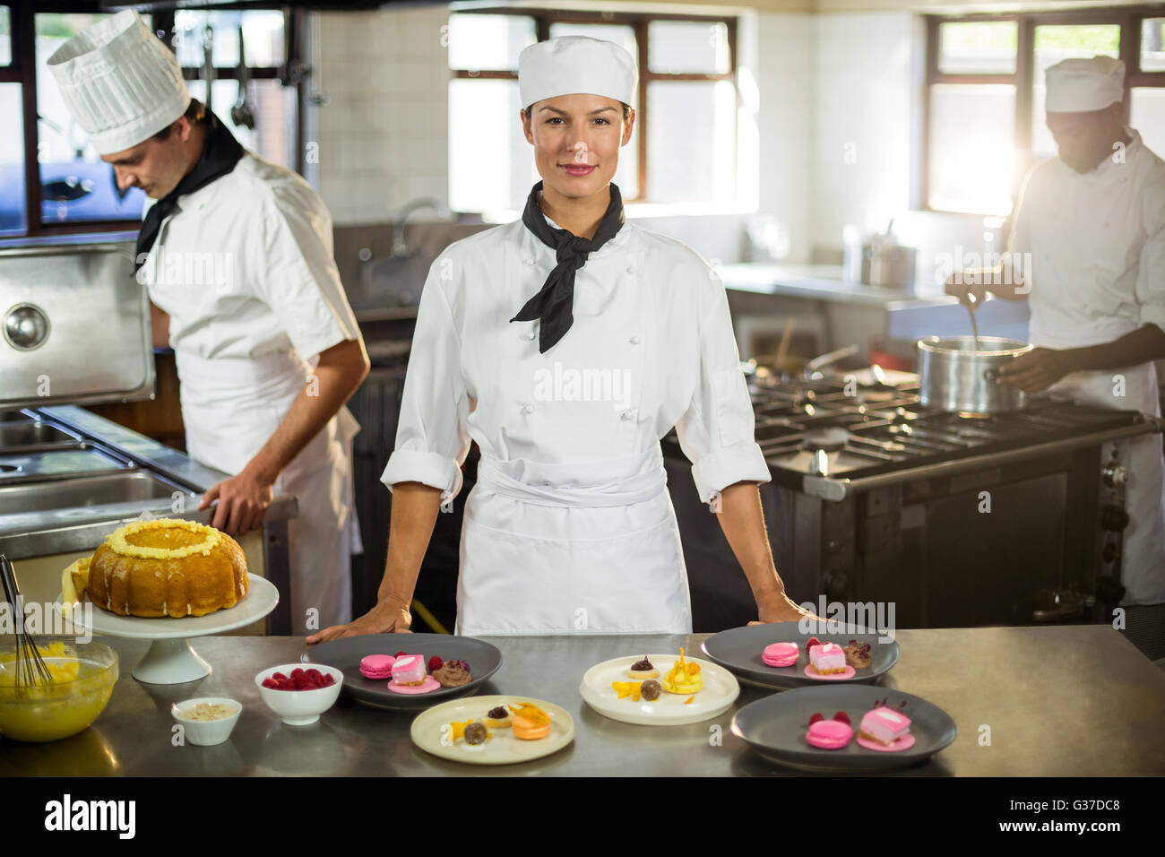 Portrait of female chef presenting dessert plates Stock Photo - Alamy