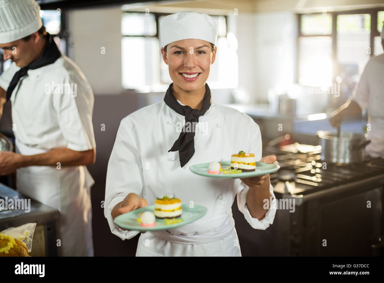 Portrait of chef presenting dessert plates Stock Photo - Alamy