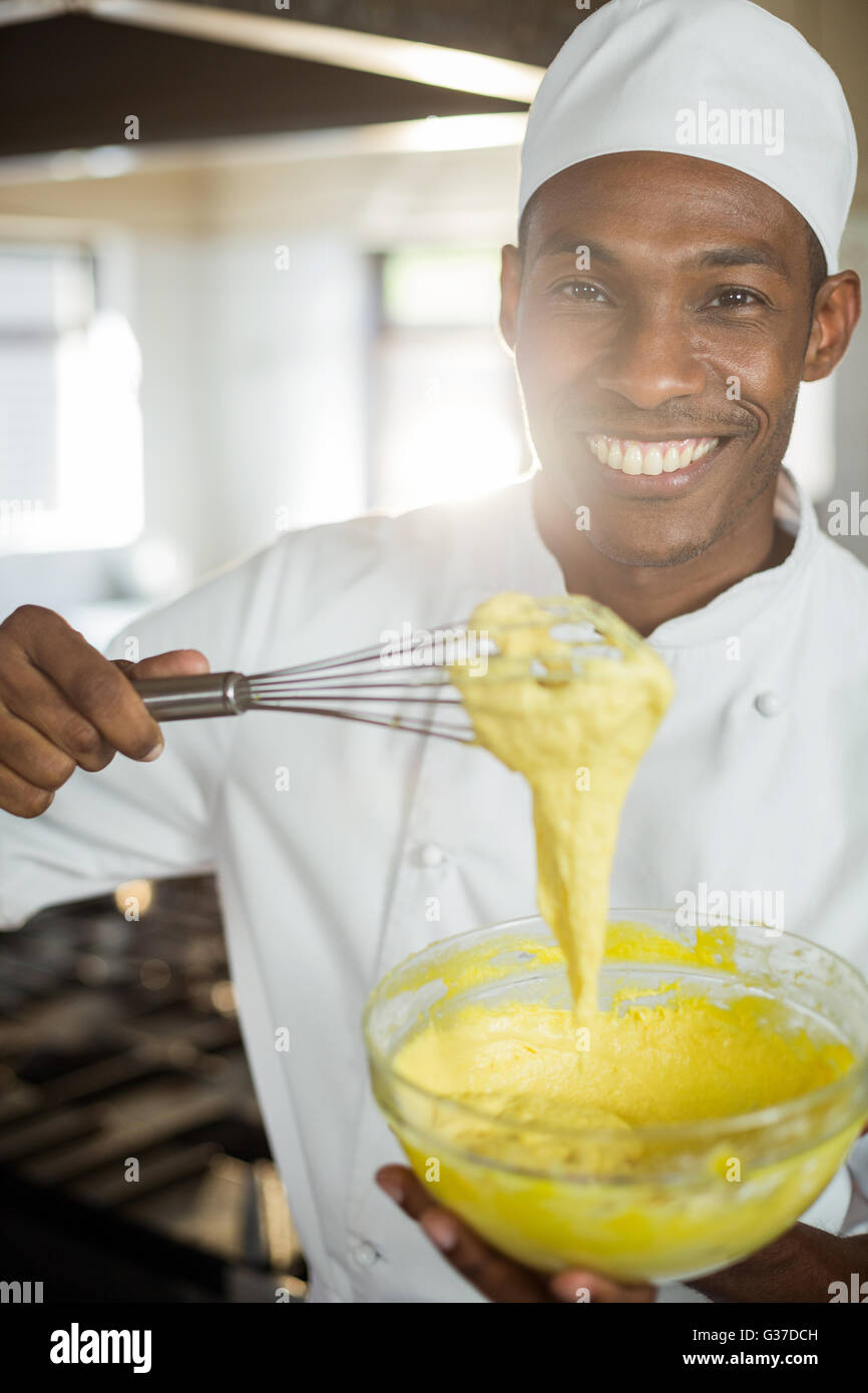 Portrait of smiling chef mixing dough Stock Photo - Alamy