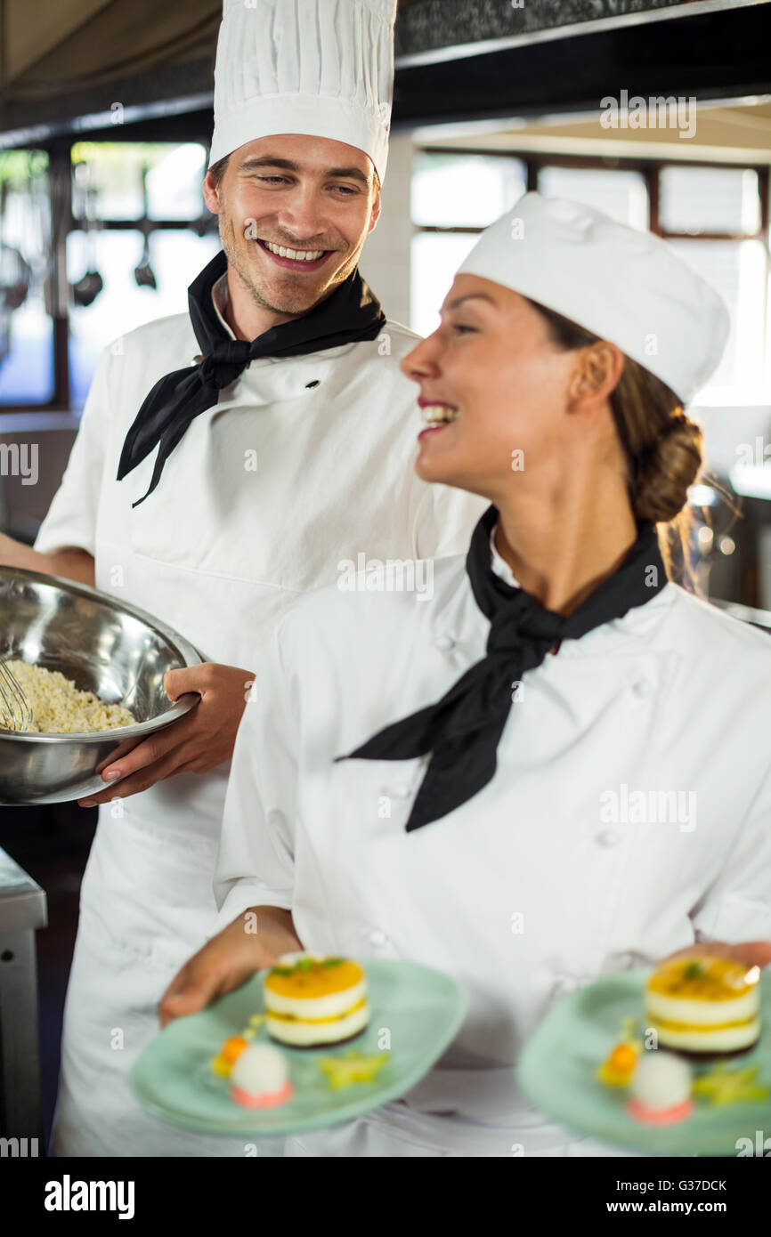 Close-up of chefs smiling while working in kitchen Stock Photo - Alamy