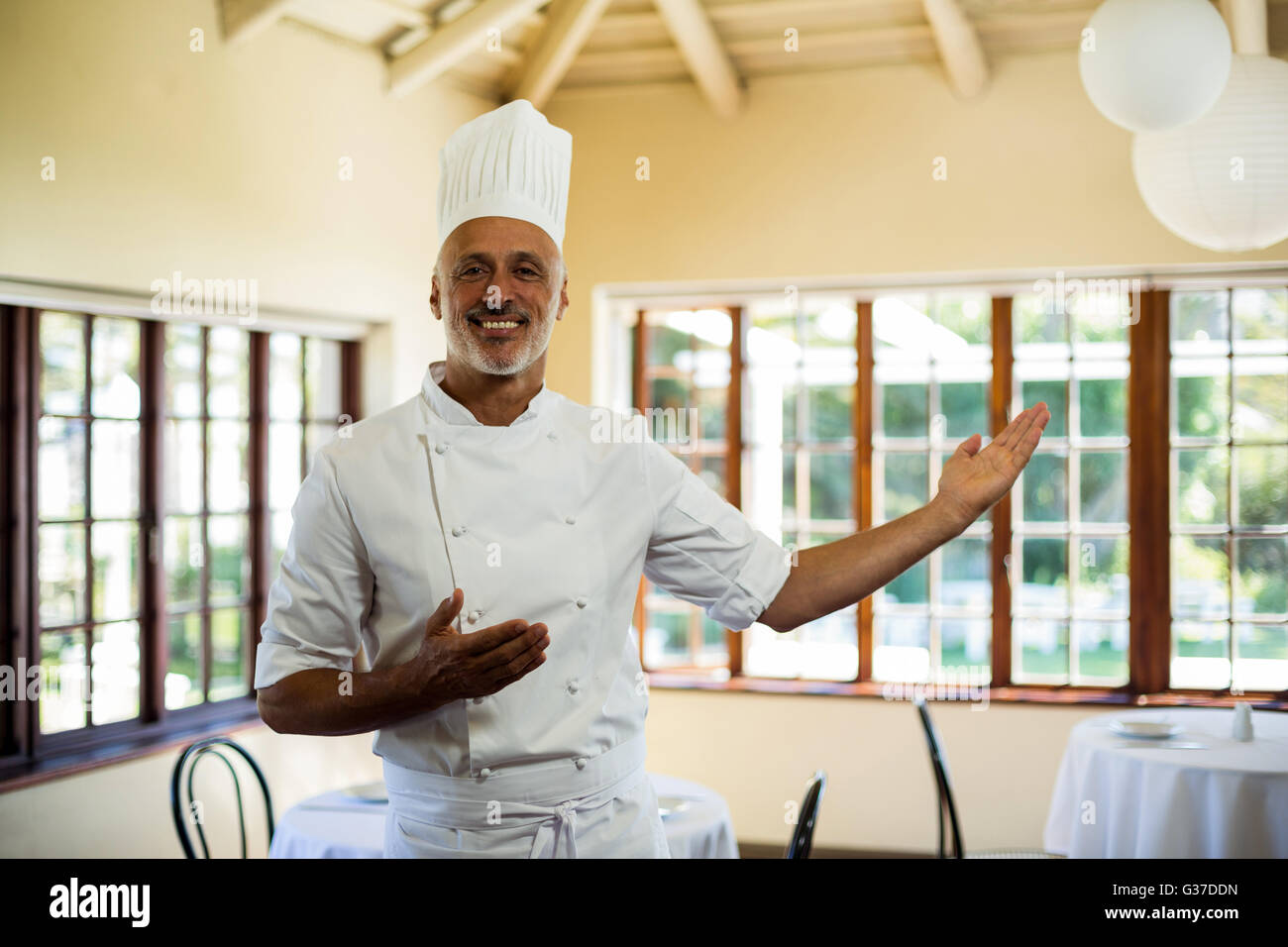 Portrait of smiling chef welcoming Stock Photo - Alamy