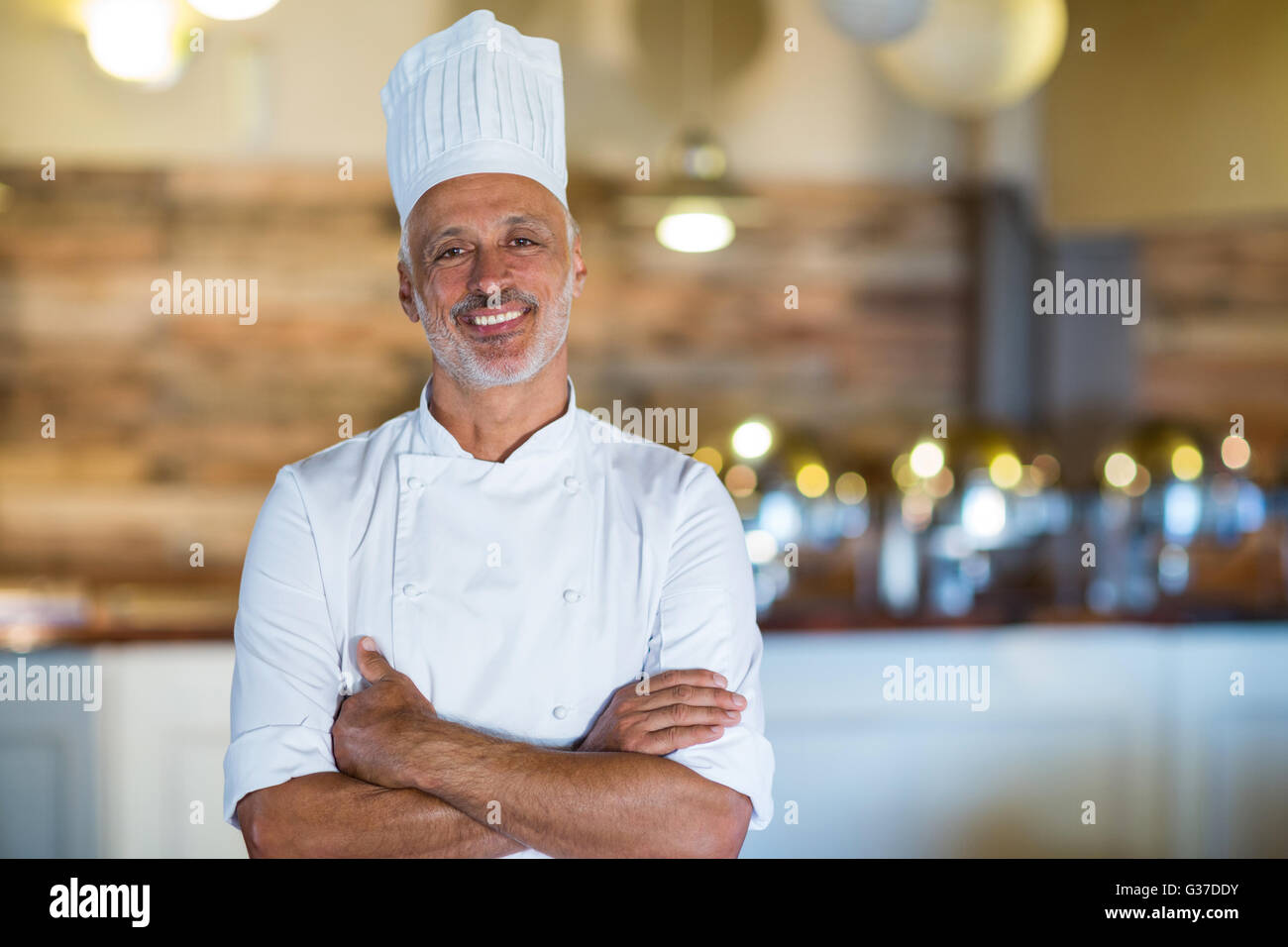 Portrait of smiling chef standing with arms crossed Stock Photo - Alamy