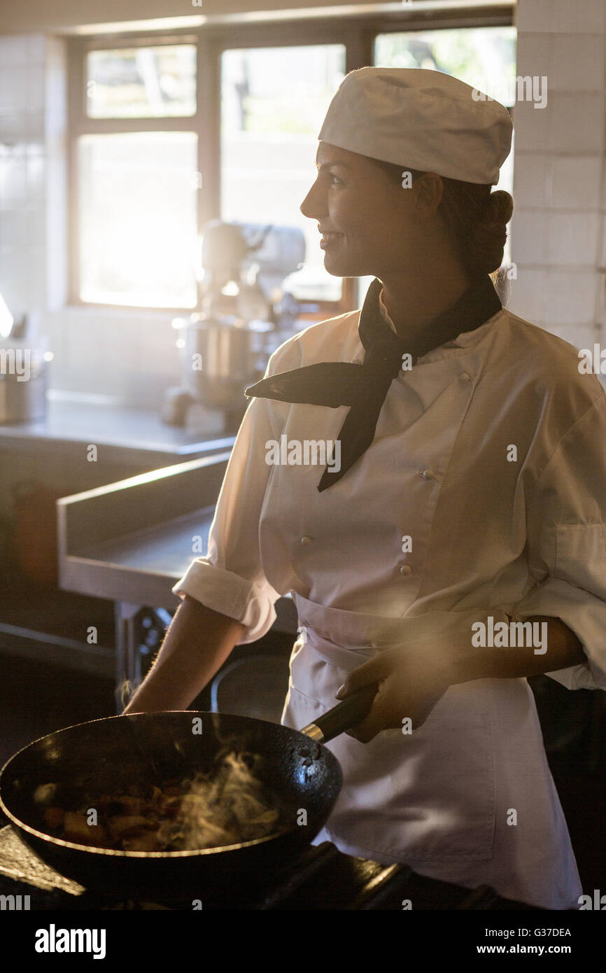 Chef preparing food at stove Stock Photo - Alamy