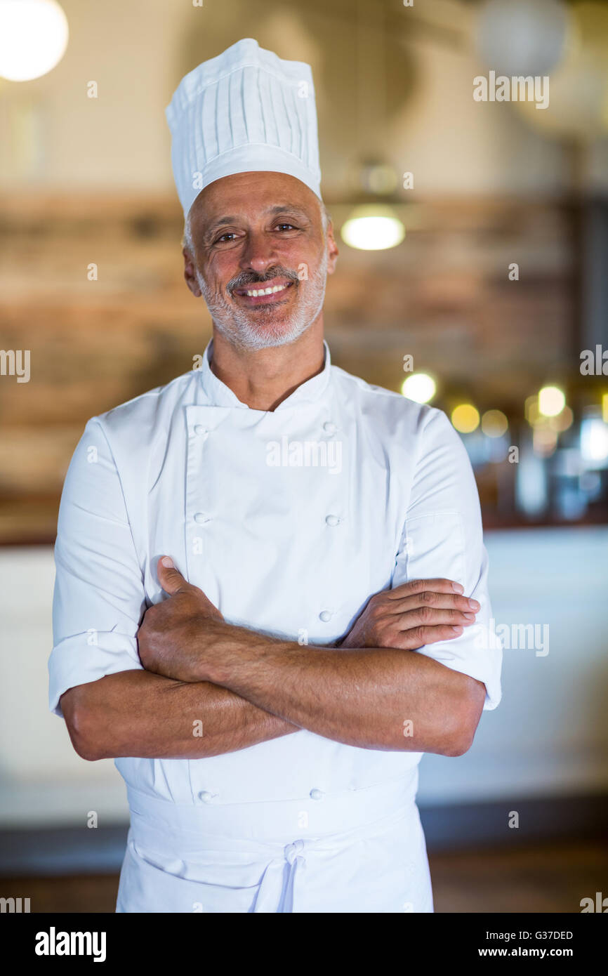 Portrait of smiling chef standing with arms crossed Stock Photo - Alamy