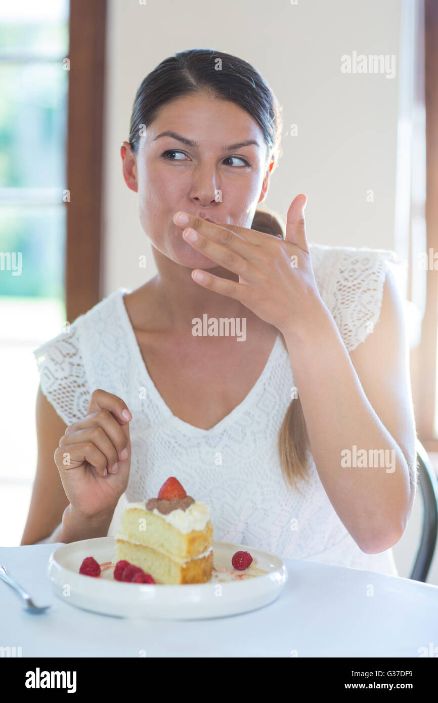 Woman having a pastry in restaurant Stock Photo - Alamy