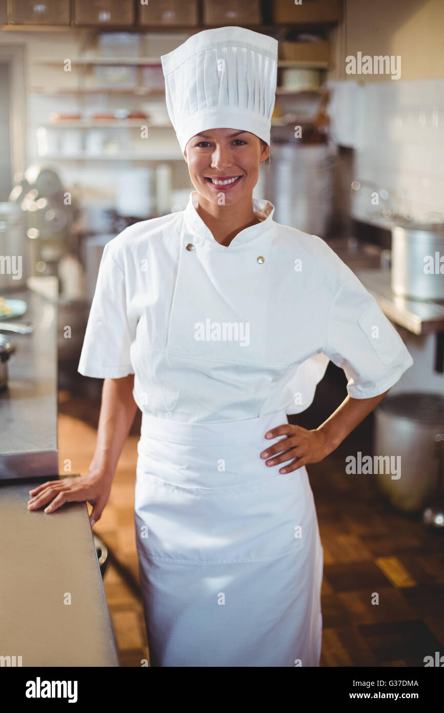 Portrait of happy chef standing with hand on hip Stock Photo - Alamy