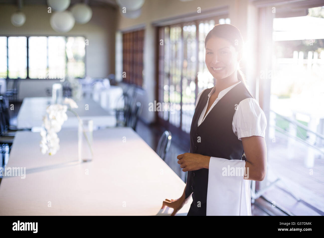Waitress with napkin draped over her hand Stock Photo - Alamy