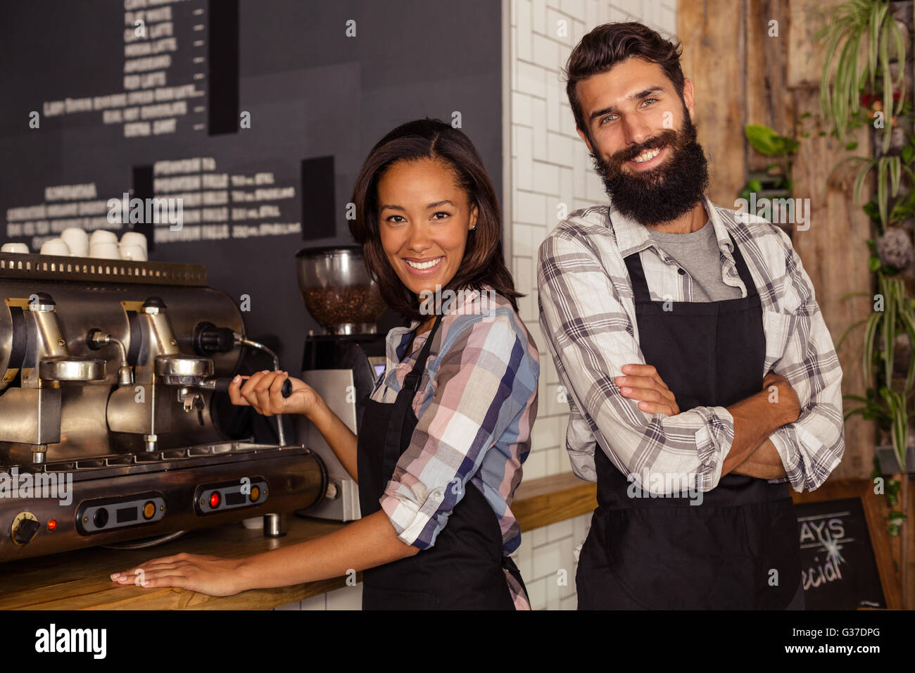 Portrait of two waiters with a coffee machine Stock Photo - Alamy