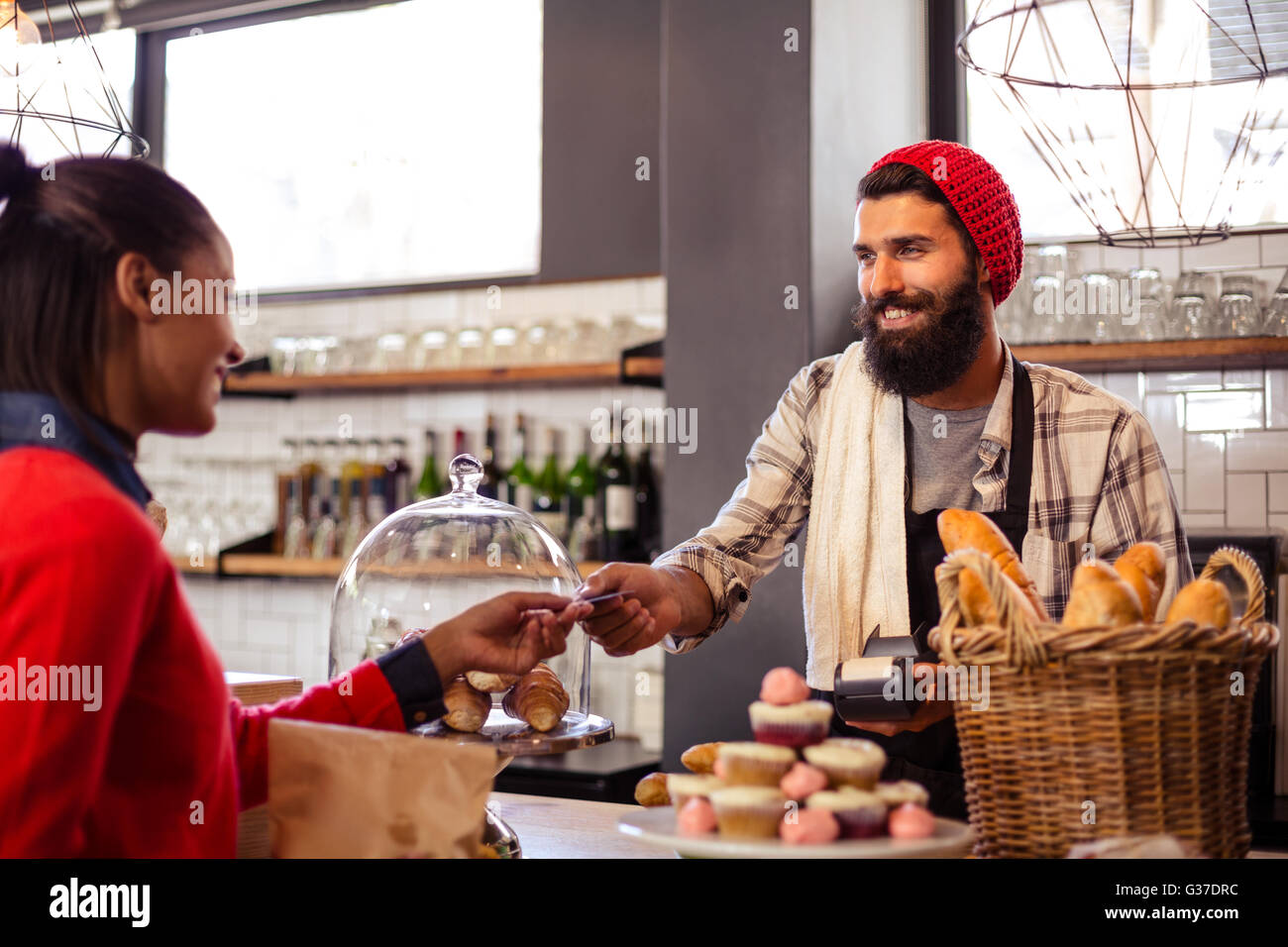 Seller taking payment Stock Photo - Alamy