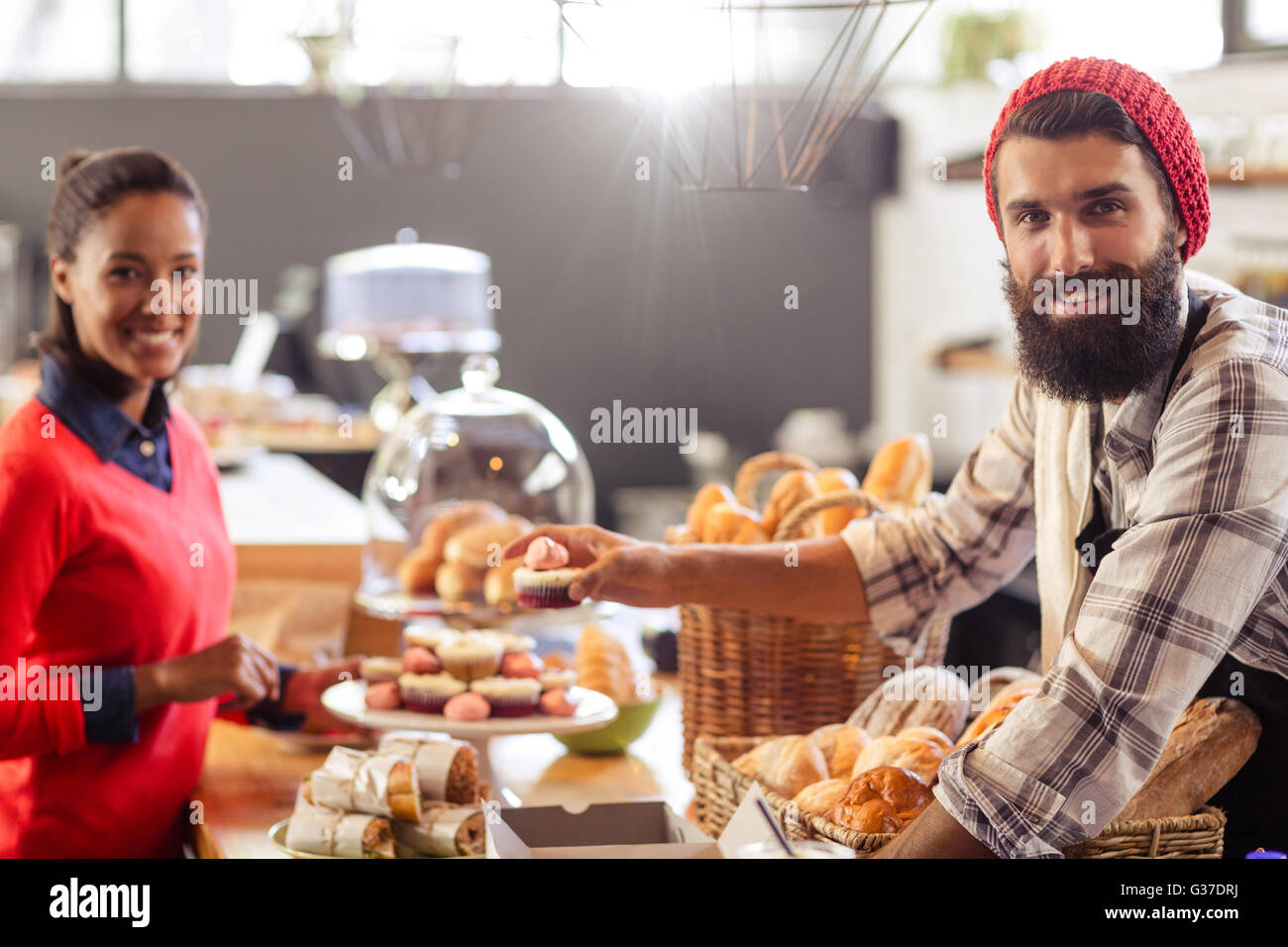 Seller serving a cake to the customer Stock Photo - Alamy