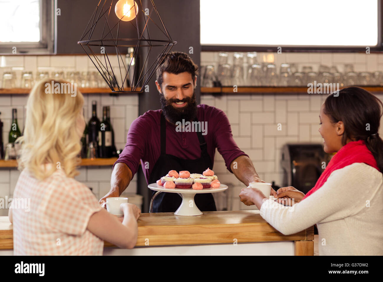 Bartender serving coffee to customers Stock Photo - Alamy