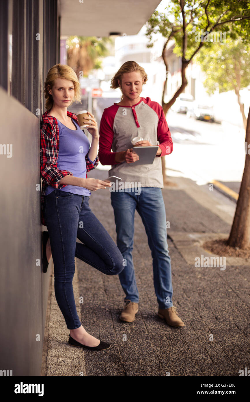 Customers using a tablet and drinking coffee Stock Photo - Alamy