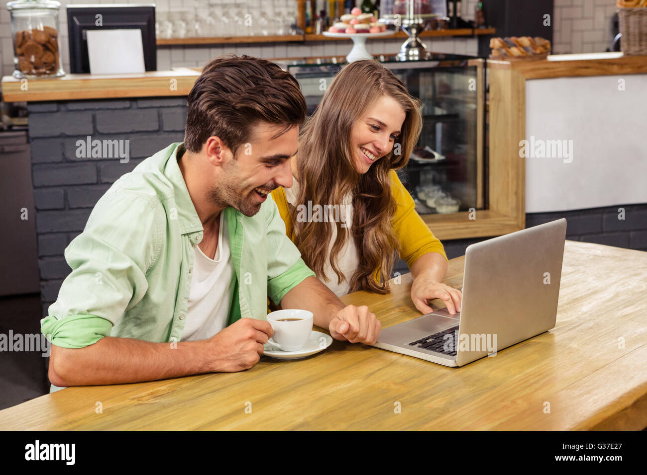 Beautiful young couple using laptop hi-res stock photography and images ...