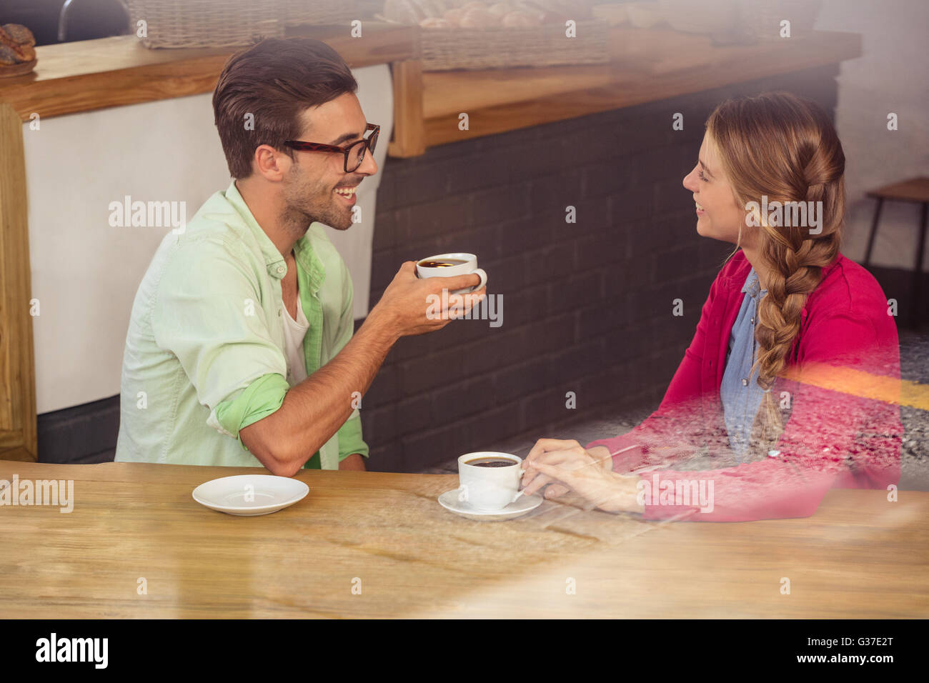 Couple interacting while drinking a coffee Stock Photo - Alamy