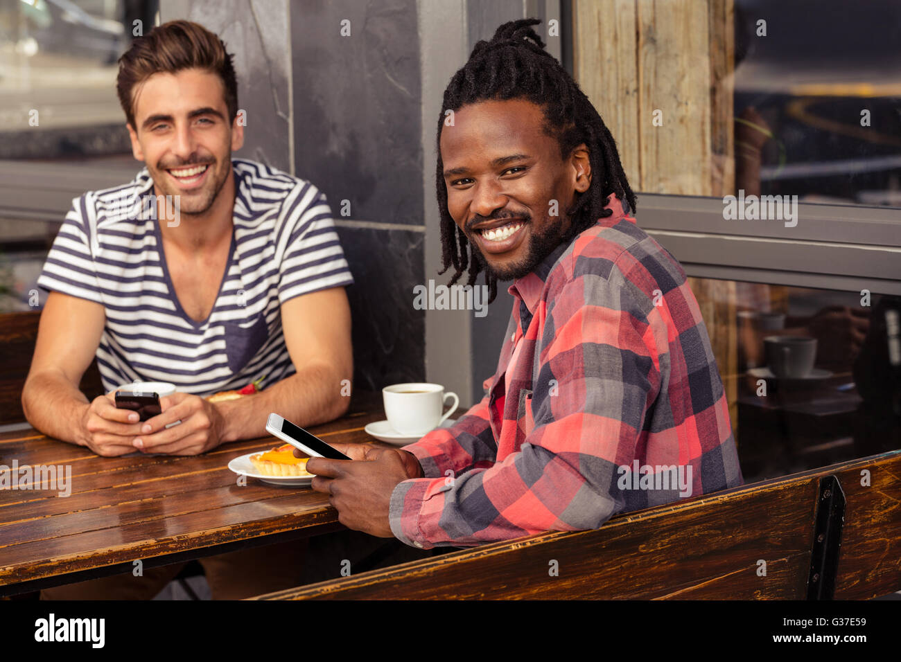 Friends using smartphones Stock Photo - Alamy