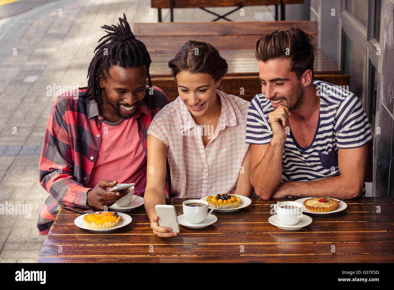 Friends using smartphones Stock Photo - Alamy