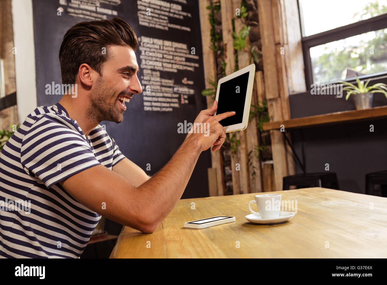 Young man tablet smartphone in hi-res stock photography and images - Alamy