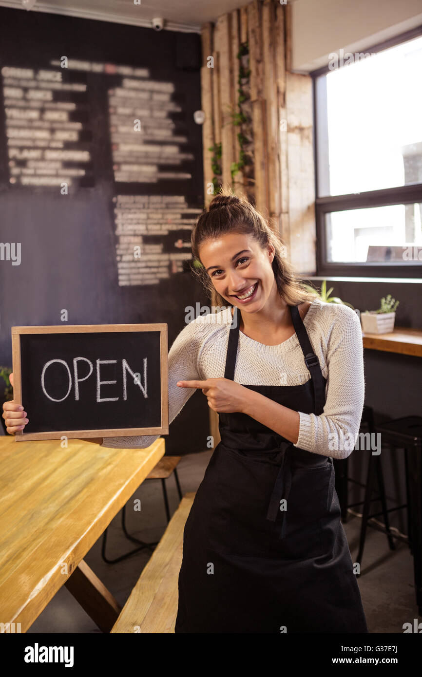 Waitress holding a sign with open Stock Photo - Alamy