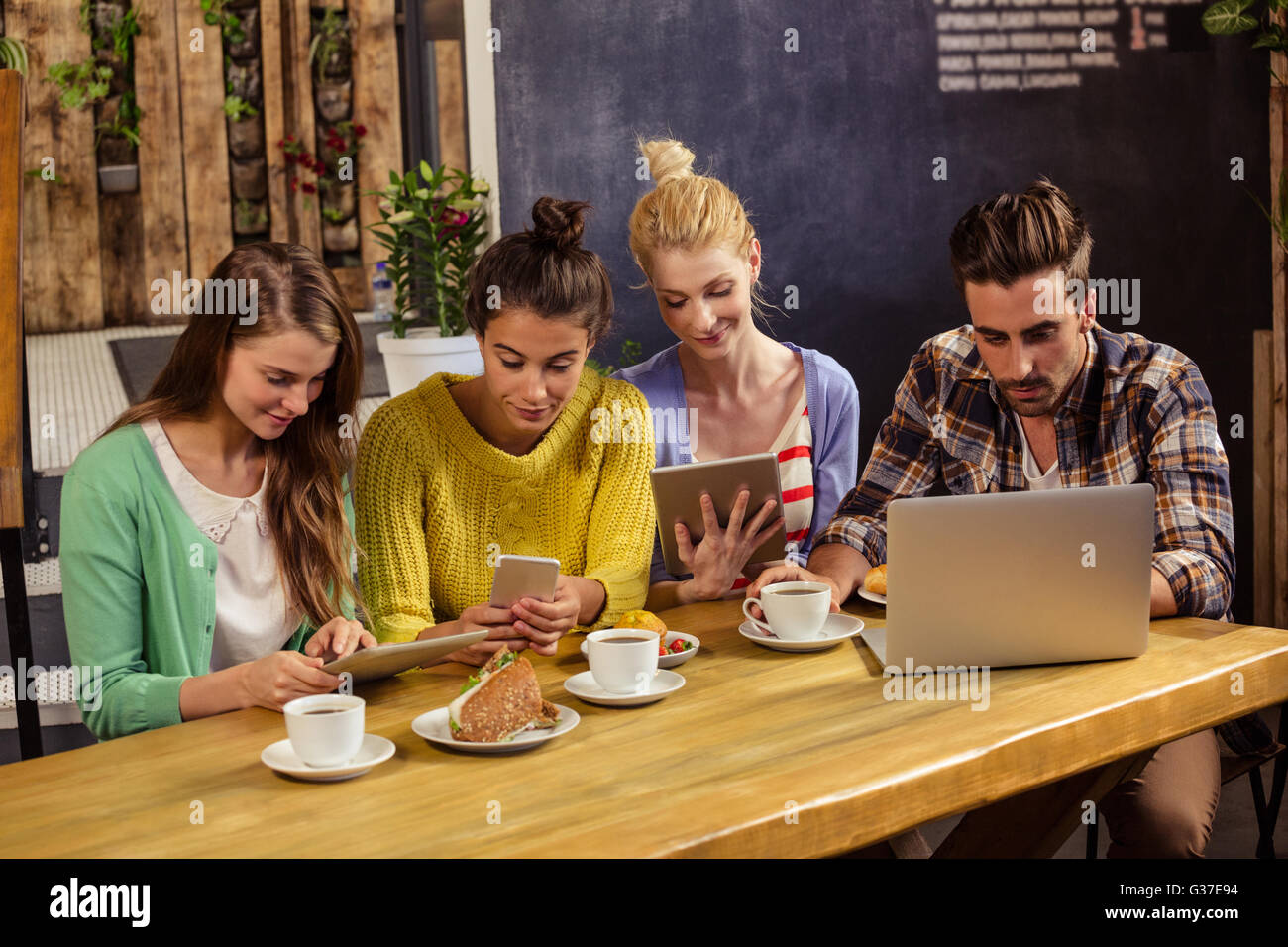 Friends using technology Stock Photo - Alamy