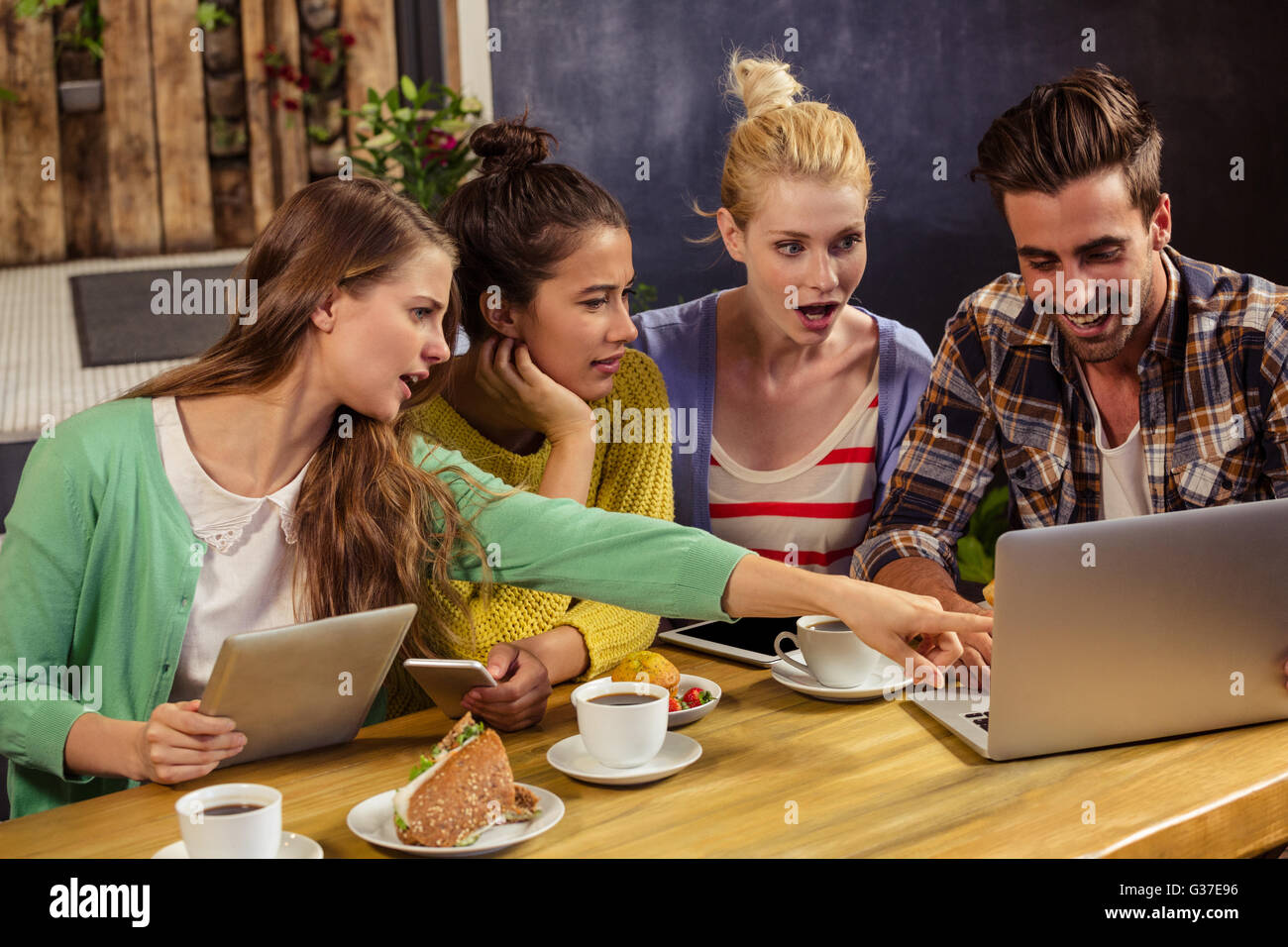 Friends using technology Stock Photo - Alamy
