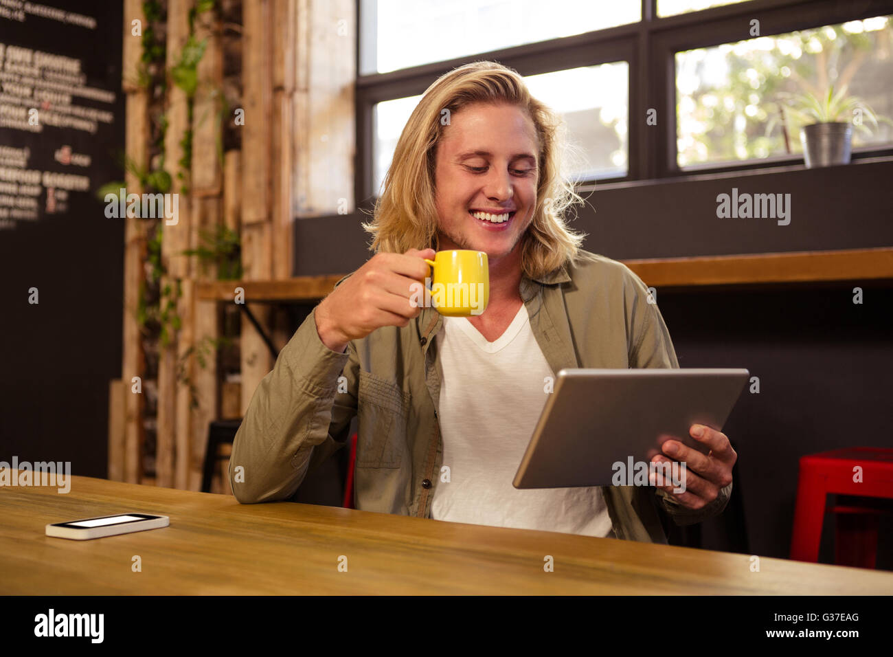 Young man tablet smartphone in hi-res stock photography and images - Alamy
