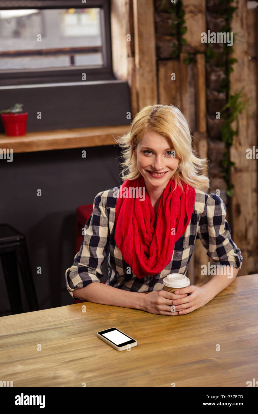 Young woman sitting in cafeteria Stock Photo - Alamy