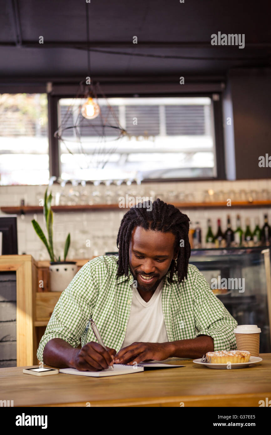 Man writing notebook table hi-res stock photography and images - Alamy