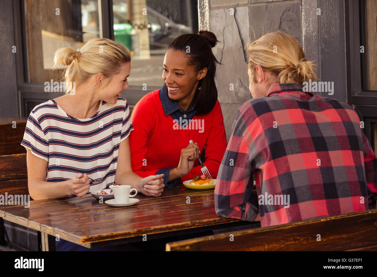 Friends sitting together Stock Photo - Alamy