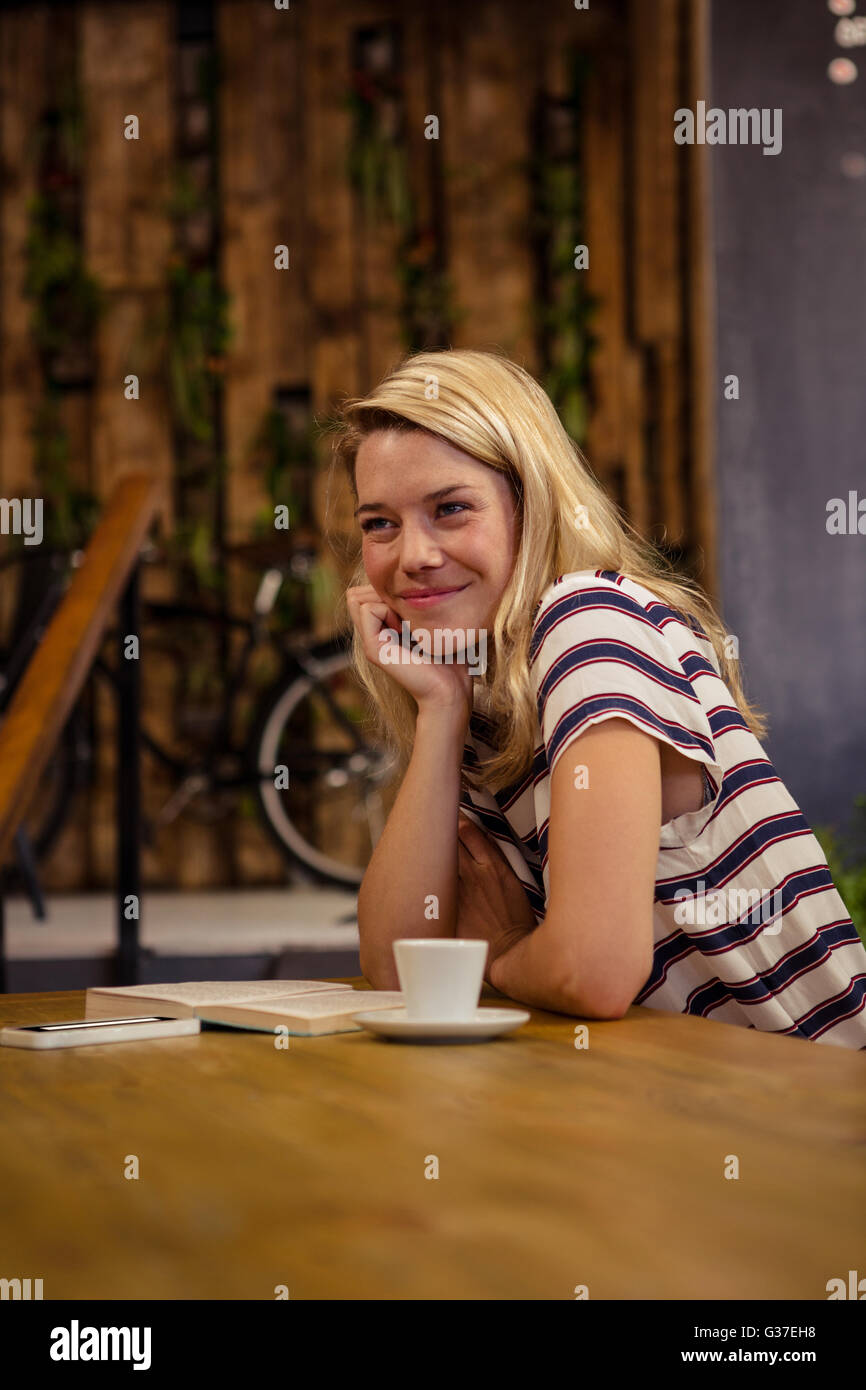 Beautiful woman sitting table hi-res stock photography and images - Alamy