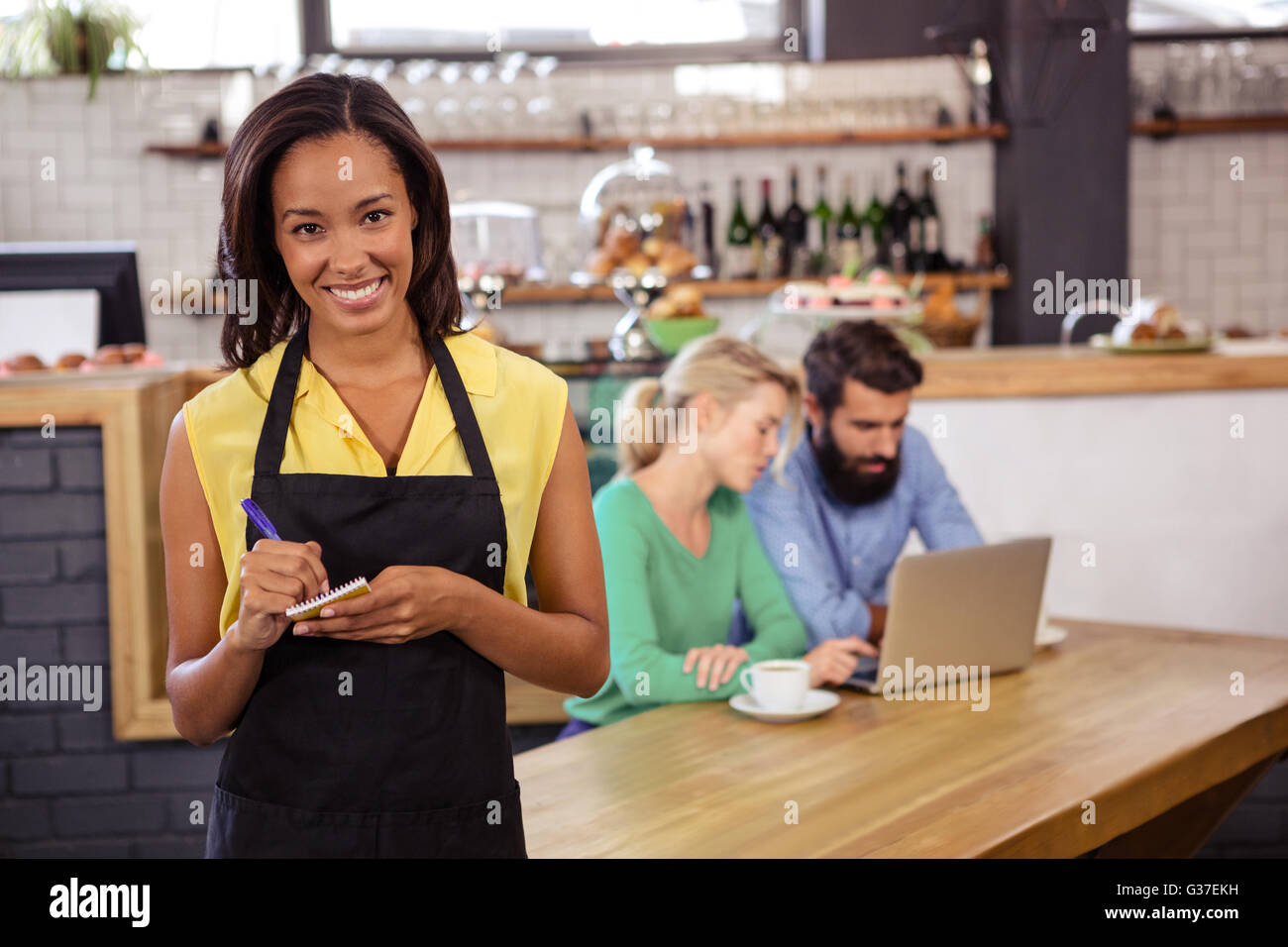 Waitress taking order on a notebook Stock Photo - Alamy