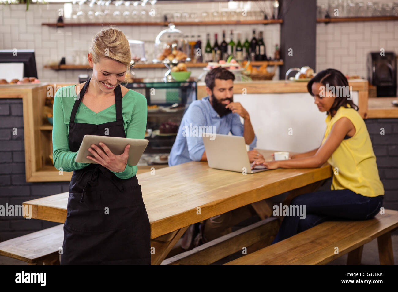 Waitress using a tablet Stock Photo - Alamy