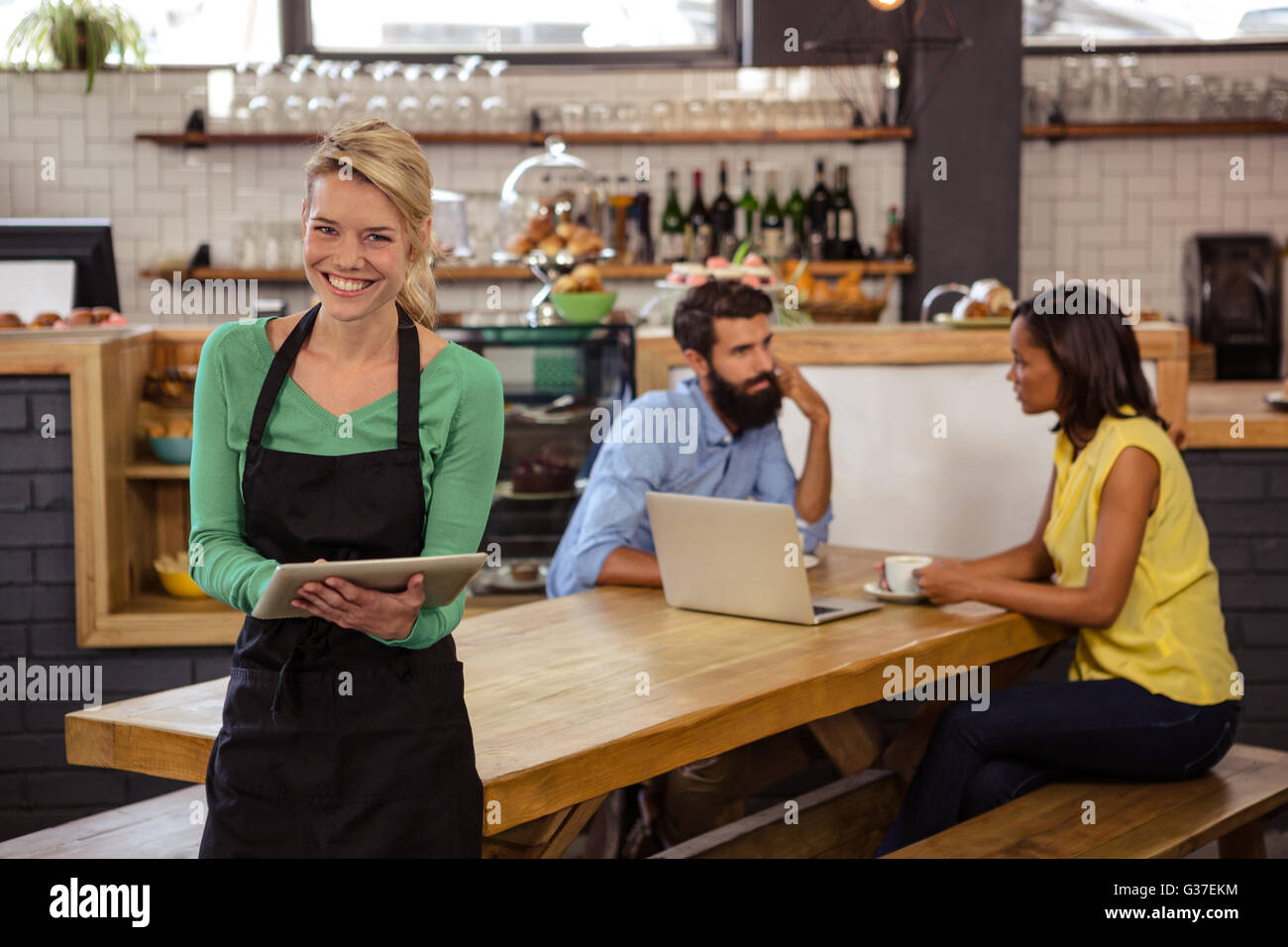 Waitress holding a tablet Stock Photo - Alamy