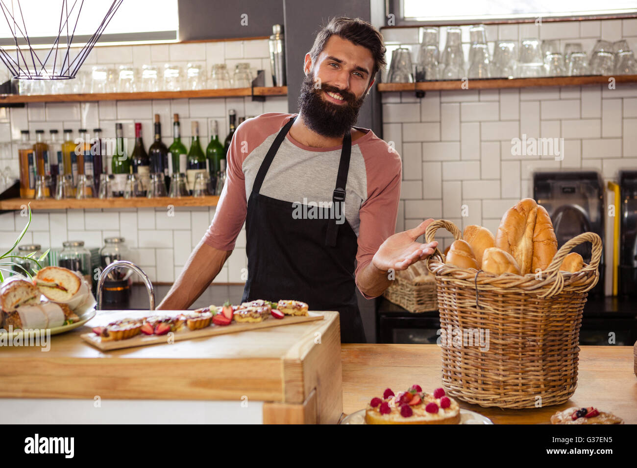 Waiter presenting food Stock Photo - Alamy