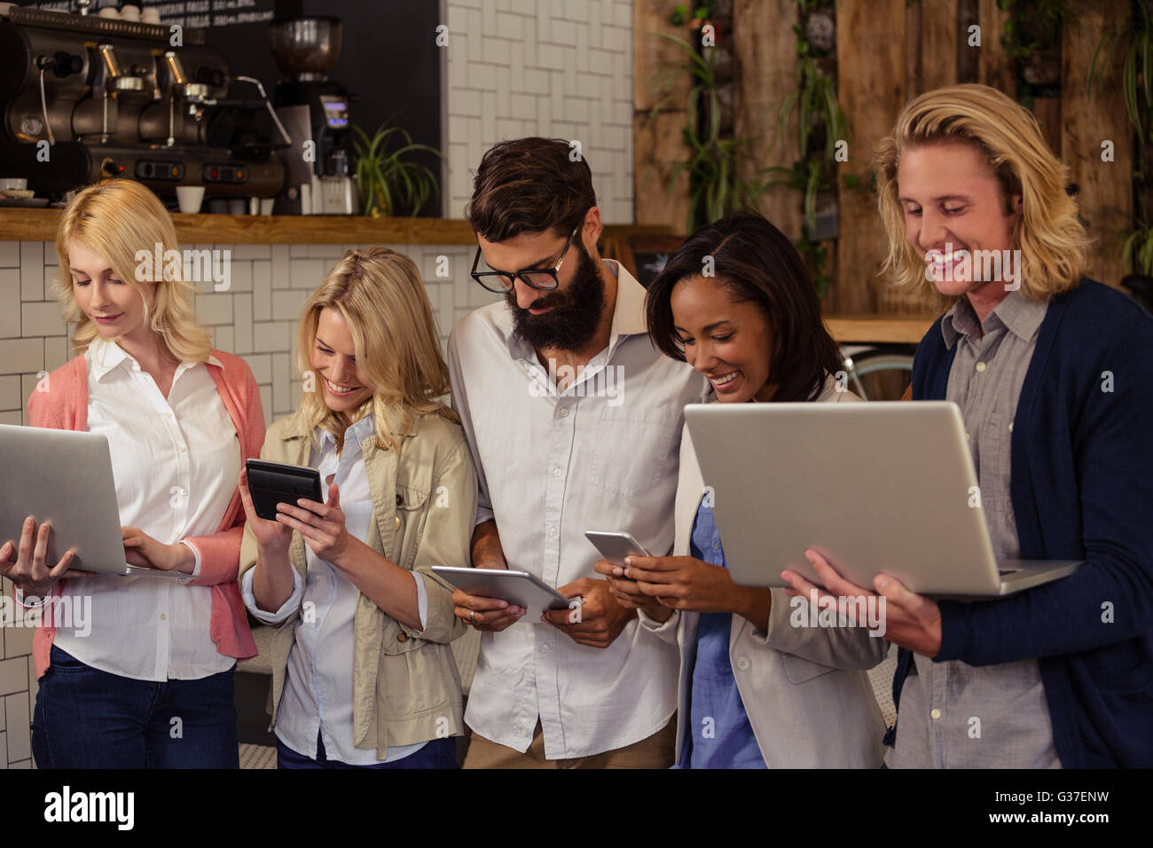 Friends using technology Stock Photo - Alamy