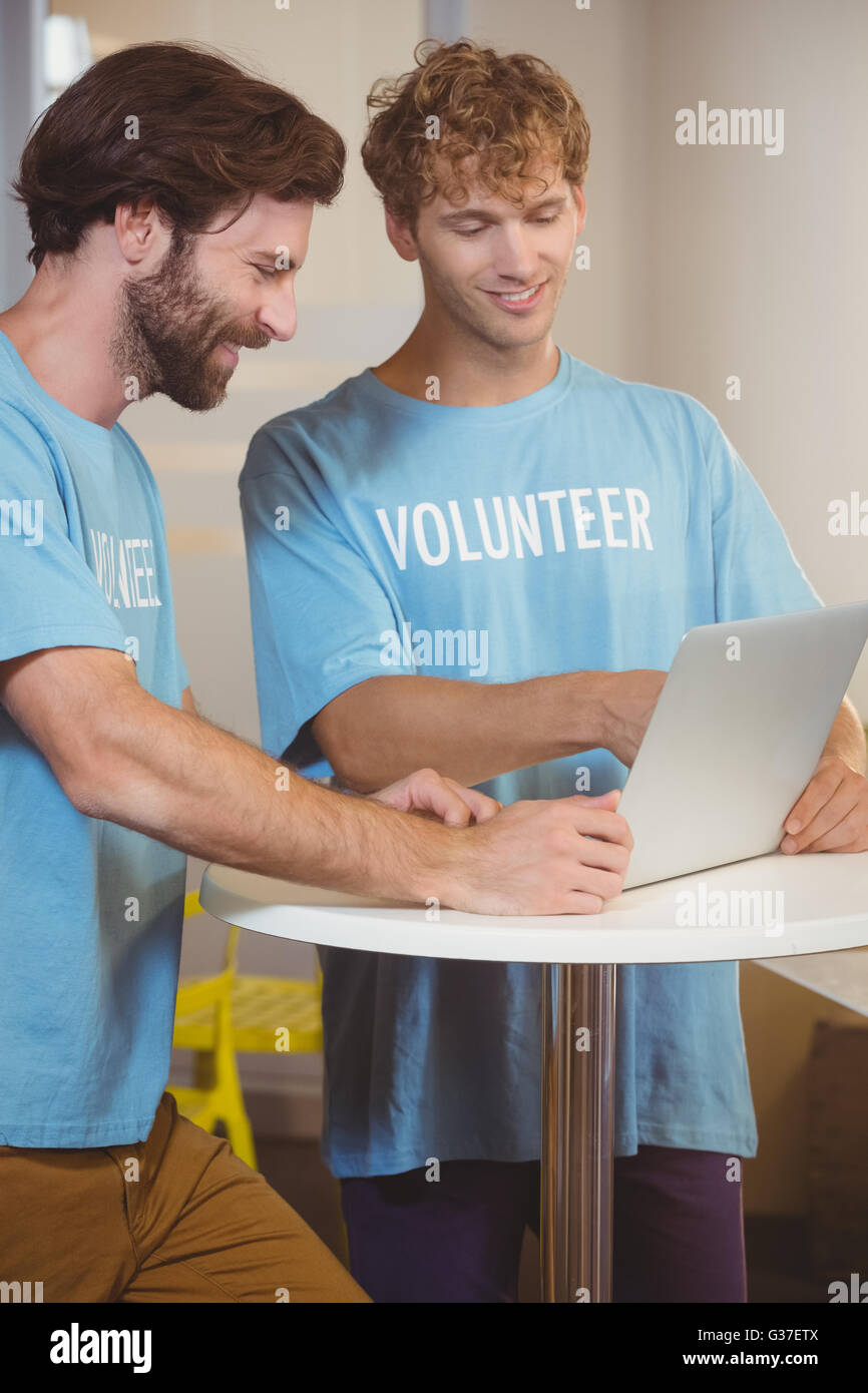 Volunteers using a laptop Stock Photo - Alamy