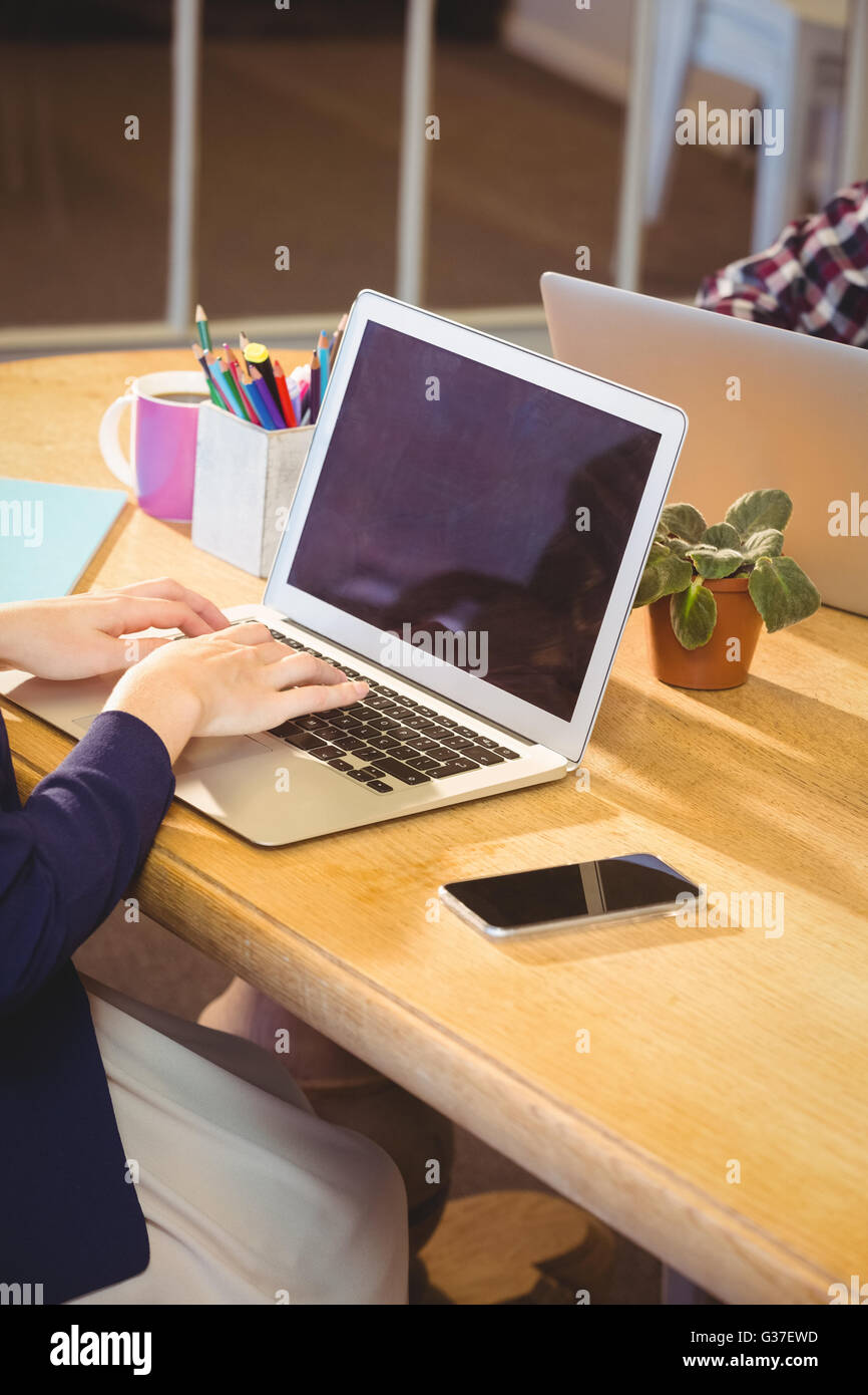 Co workers using laptop hi-res stock photography and images - Alamy