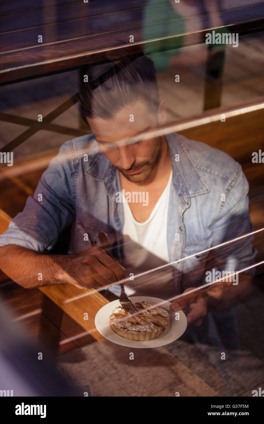 Facing view of hipster man eating pastries Stock Photo - Alamy