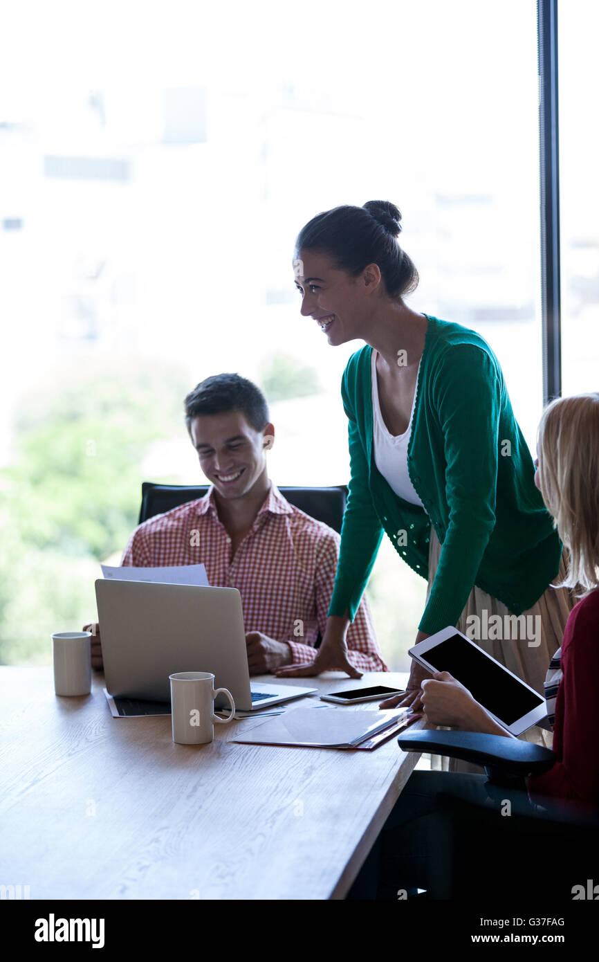 Coworkers smiling during a meeting Stock Photo - Alamy
