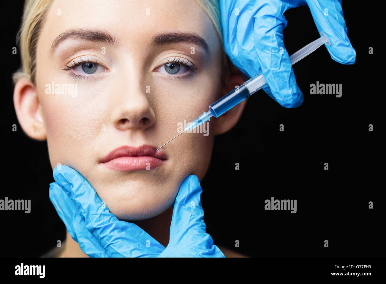 Woman receiving botox injection on her lips Stock Photo - Alamy
