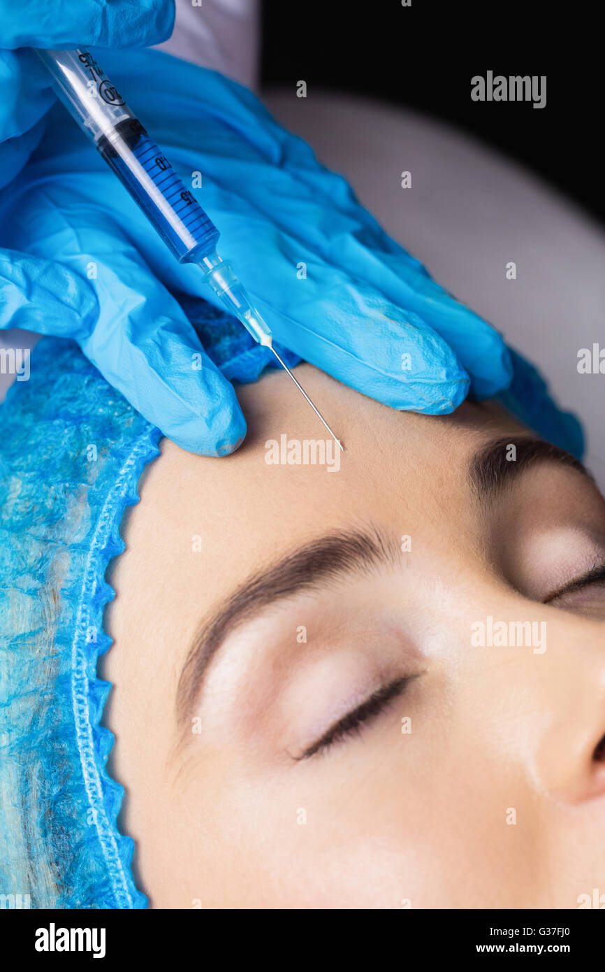 Woman receiving botox injection on her forehead Stock Photo - Alamy
