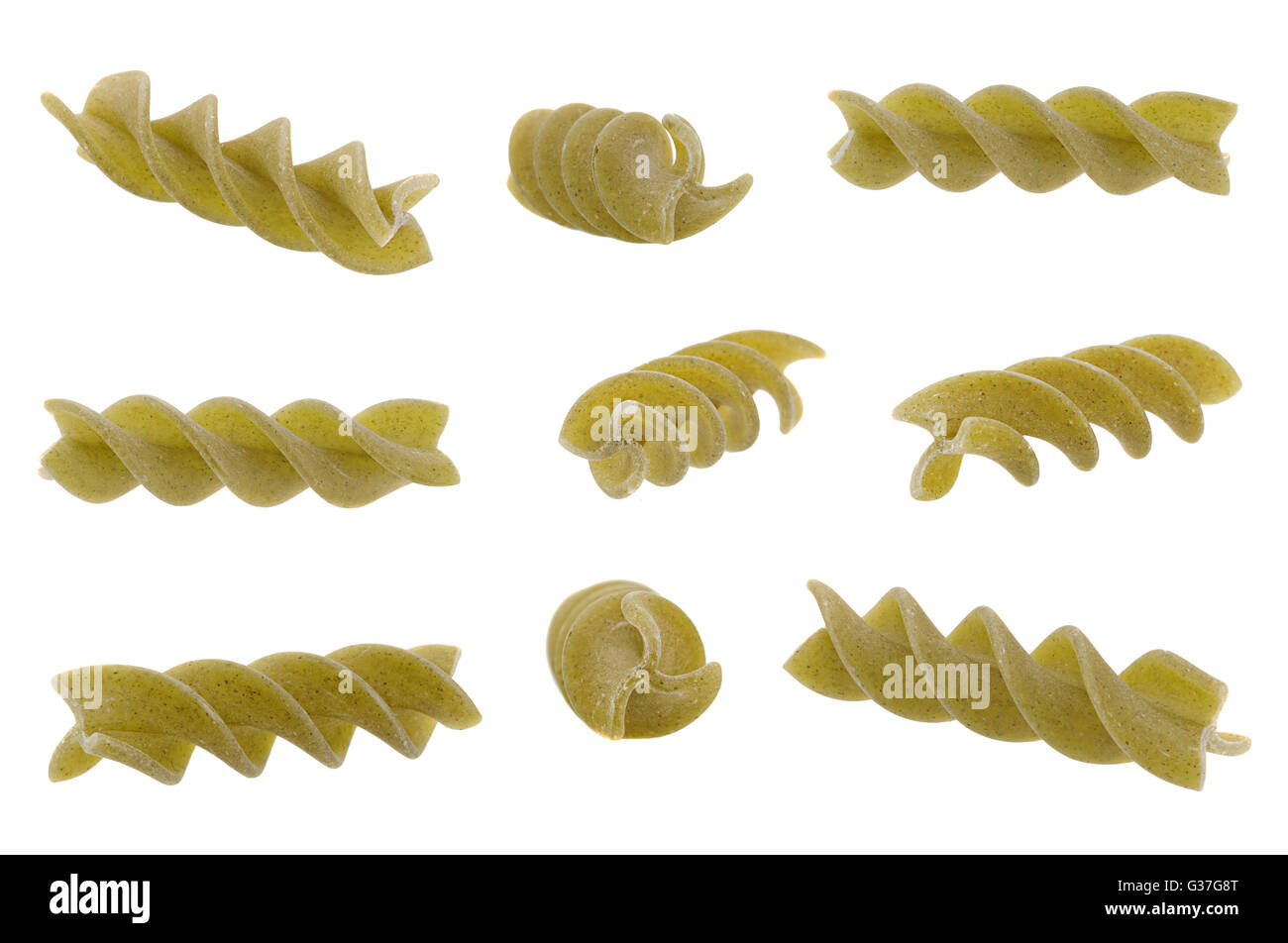 Green swirl dry pasta closeup isolated on white background Stock Photo ...