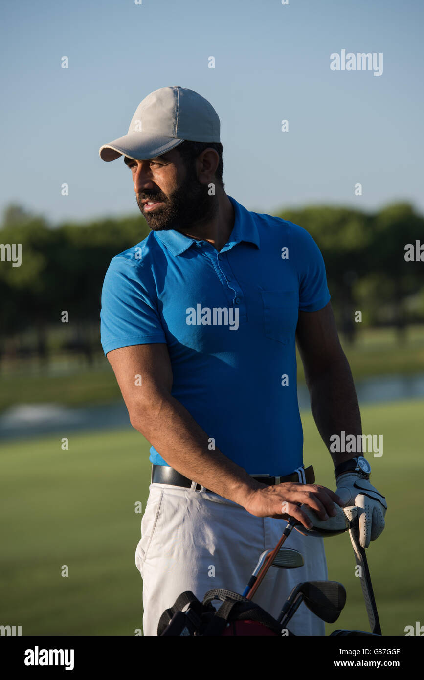 handsome middle eastern golfer portrait at golf course at sunny day ...