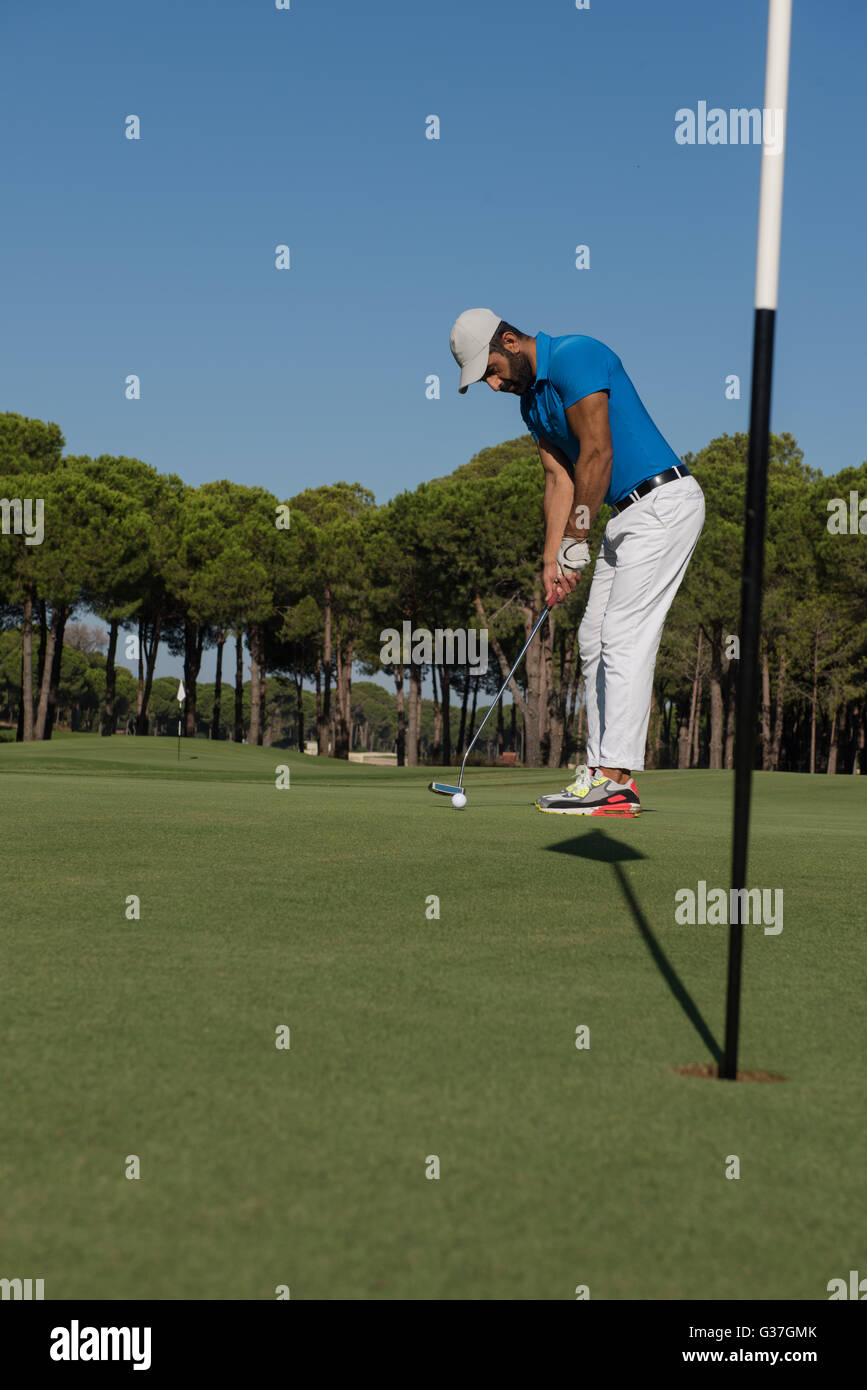 golf player hitting shot with driver on course at beautiful sunny day ...