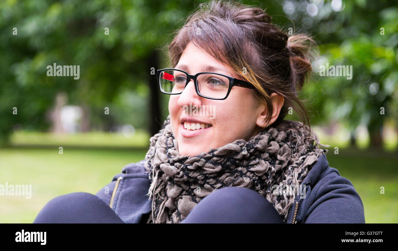 Young woman wearing scarf at a park Stock Photo - Alamy